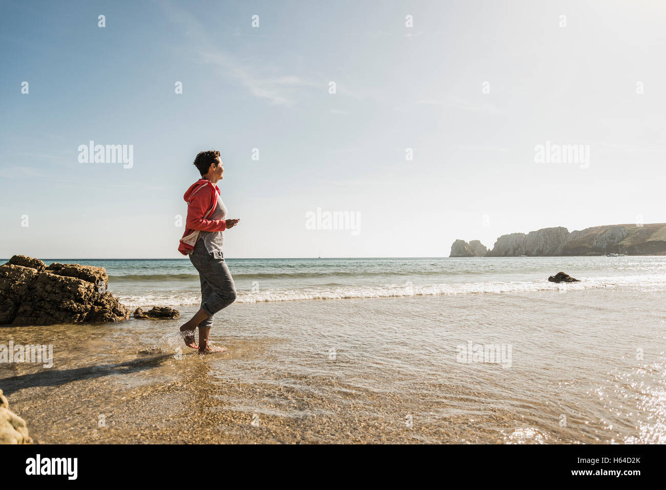 Mature woman wading in the sea Stock Photo - Alamy