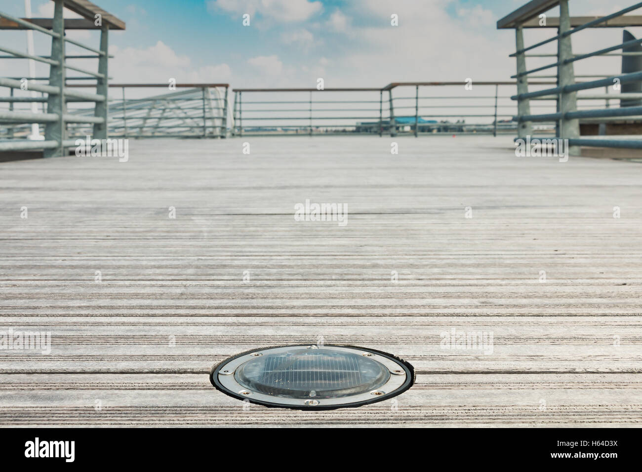 Solar Round Deck light LED on a wooden bridge with blue sky Stock Photo ...