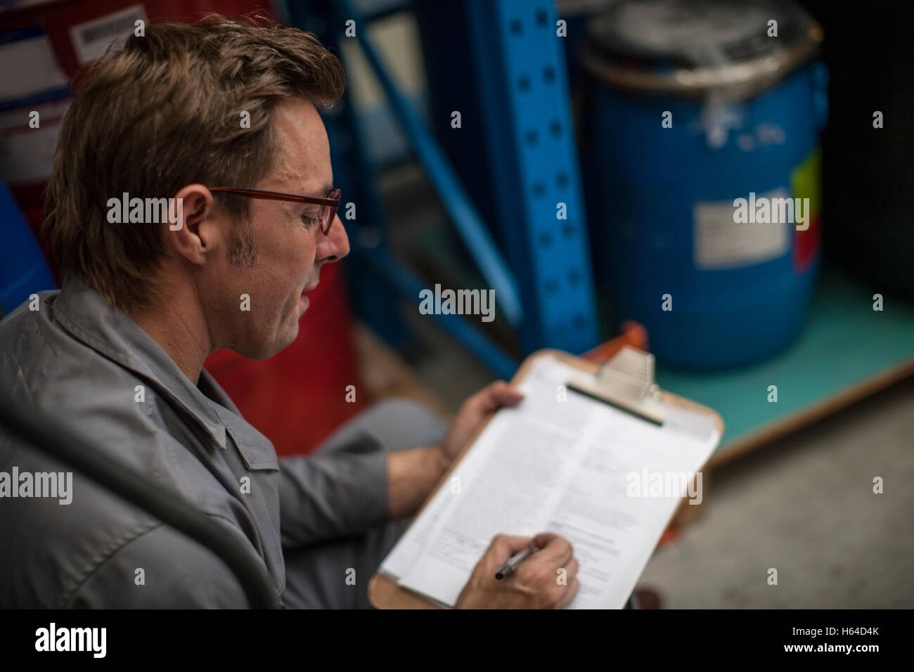 Worker taking stock in warehouse Stock Photo - Alamy