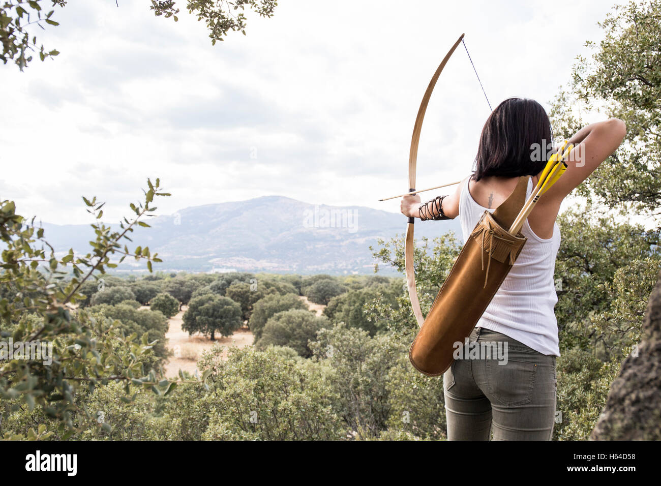 Back view of archeress aiming at distance Stock Photo - Alamy