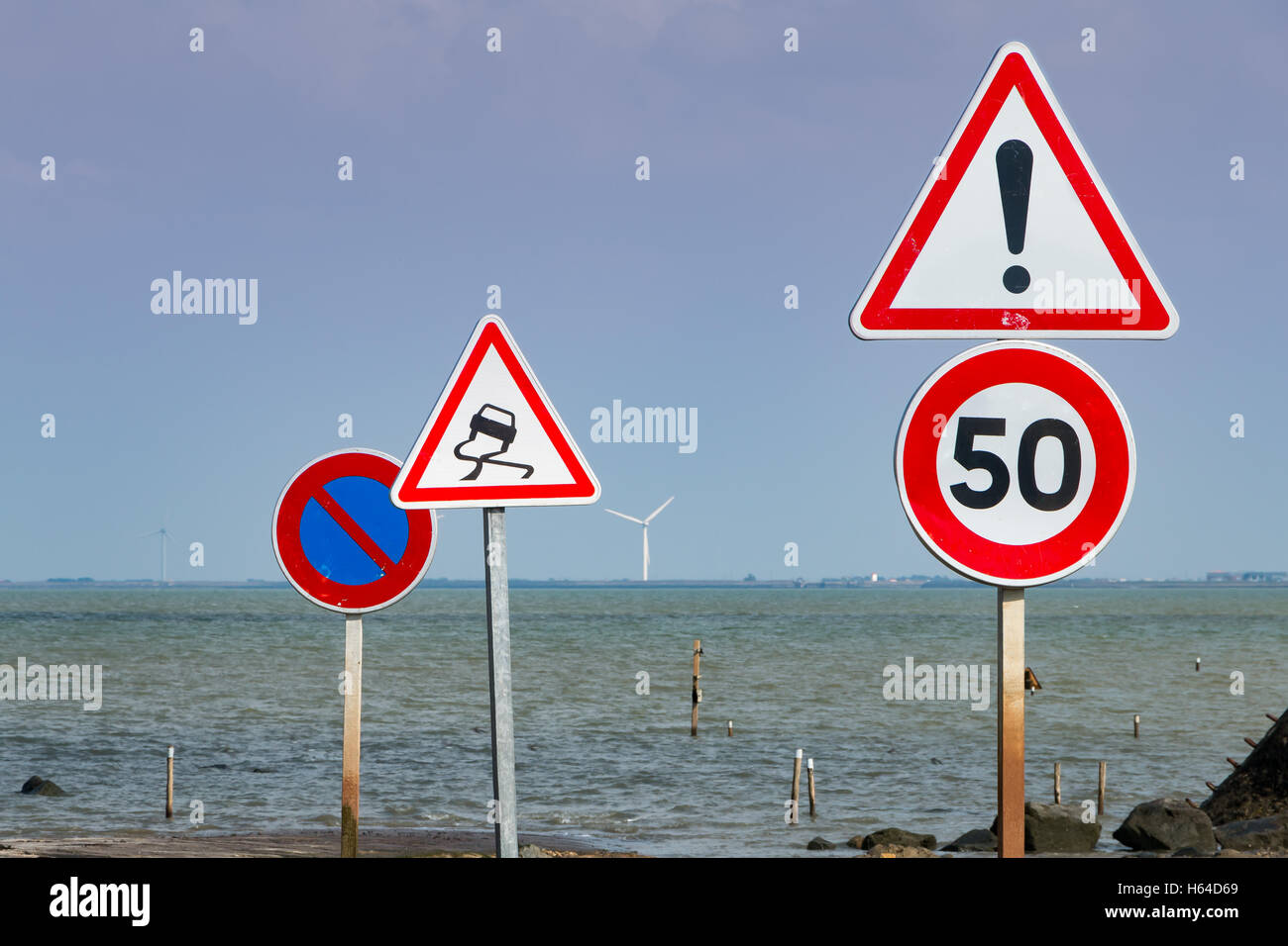 together of road signs for warning next to sea Stock Photo - Alamy