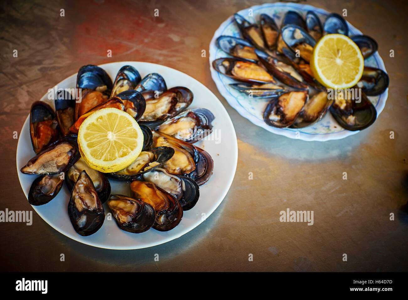 Fresh blue mussles on plates with lemon slices Stock Photo - Alamy