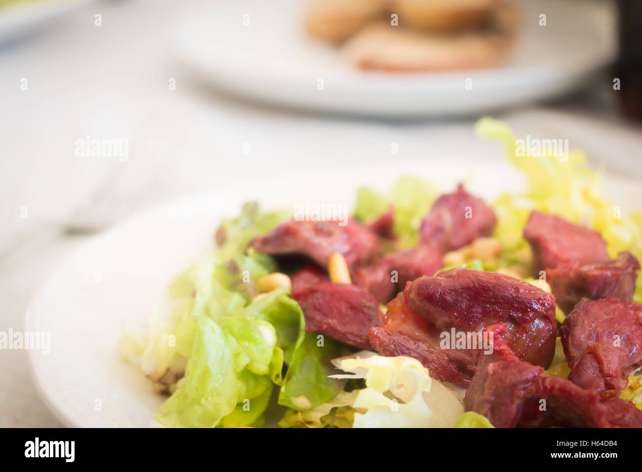 gizzards plate with salad on a table prepared Stock Photo - Alamy