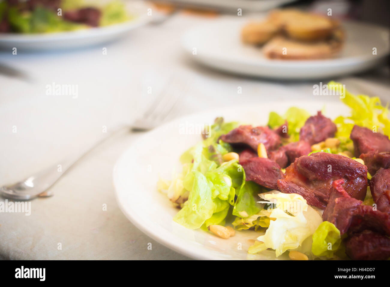 gizzards plate with salad on a table prepared Stock Photo - Alamy