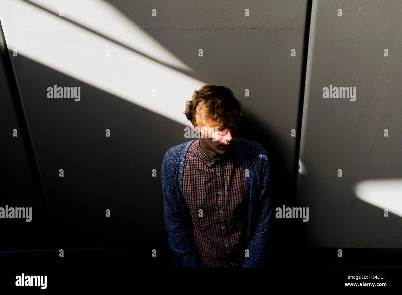 Young man between shadow and light Stock Photo - Alamy