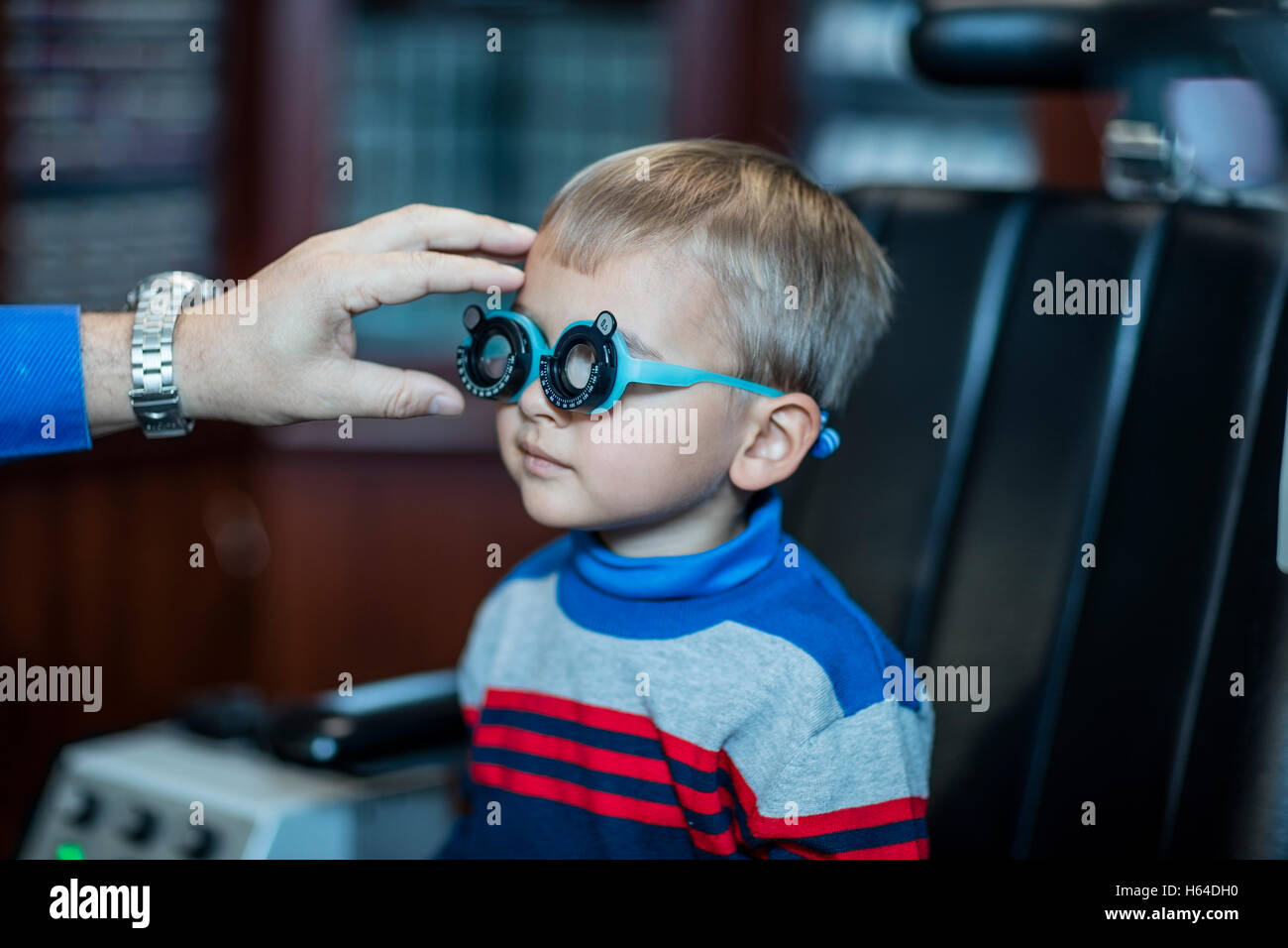 Boy doing eye test at optometrist Stock Photo - Alamy
