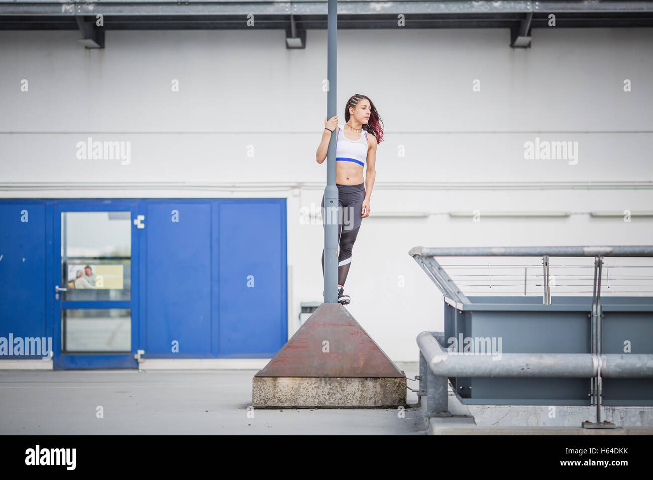 Woman standing on pillar Stock Photo - Alamy