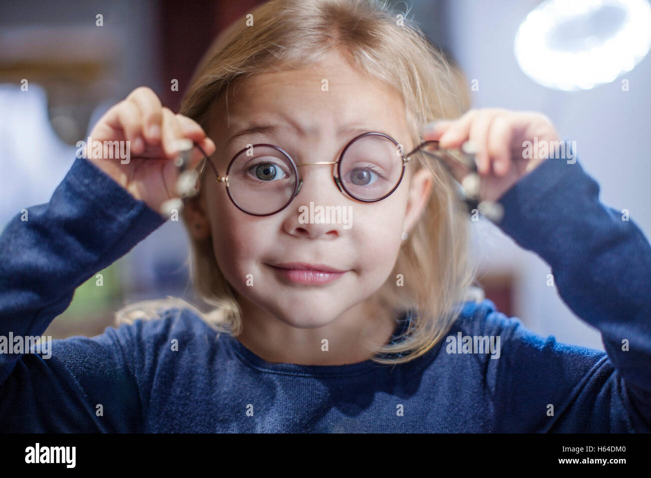 Little girl looking through spectacles Stock Photo - Alamy