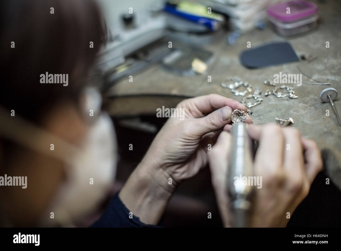Goldsmith working on jewelery in workshop Stock Photo - Alamy
