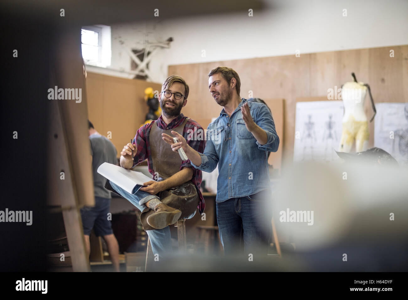 Two men in artist studio planning together Stock Photo - Alamy