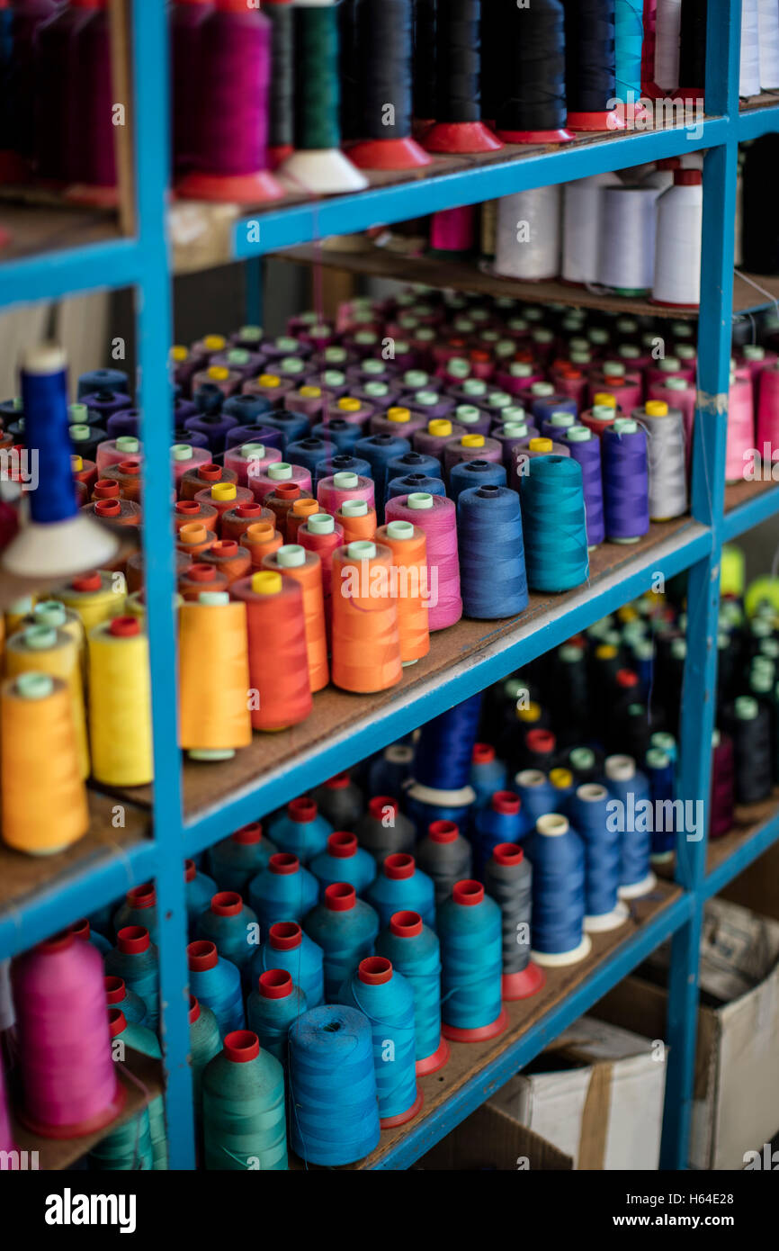 Multicolored cotton reels on shelf Stock Photo - Alamy