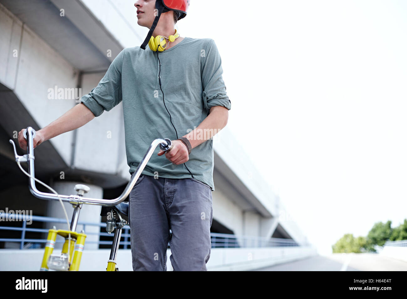 Teenage boy pushing bicycle Stock Photo - Alamy