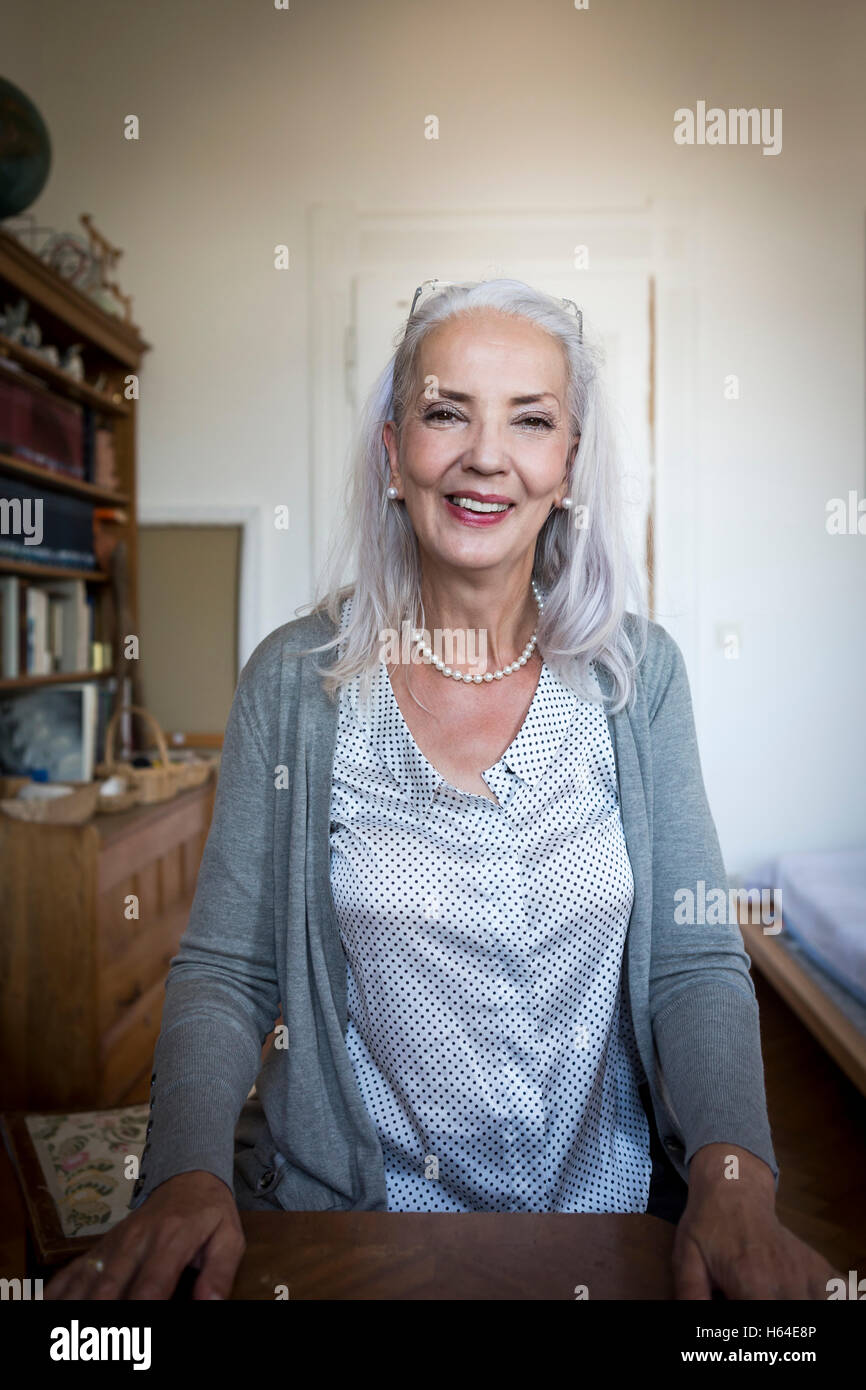 Portrait of smiling woman at home Stock Photo - Alamy