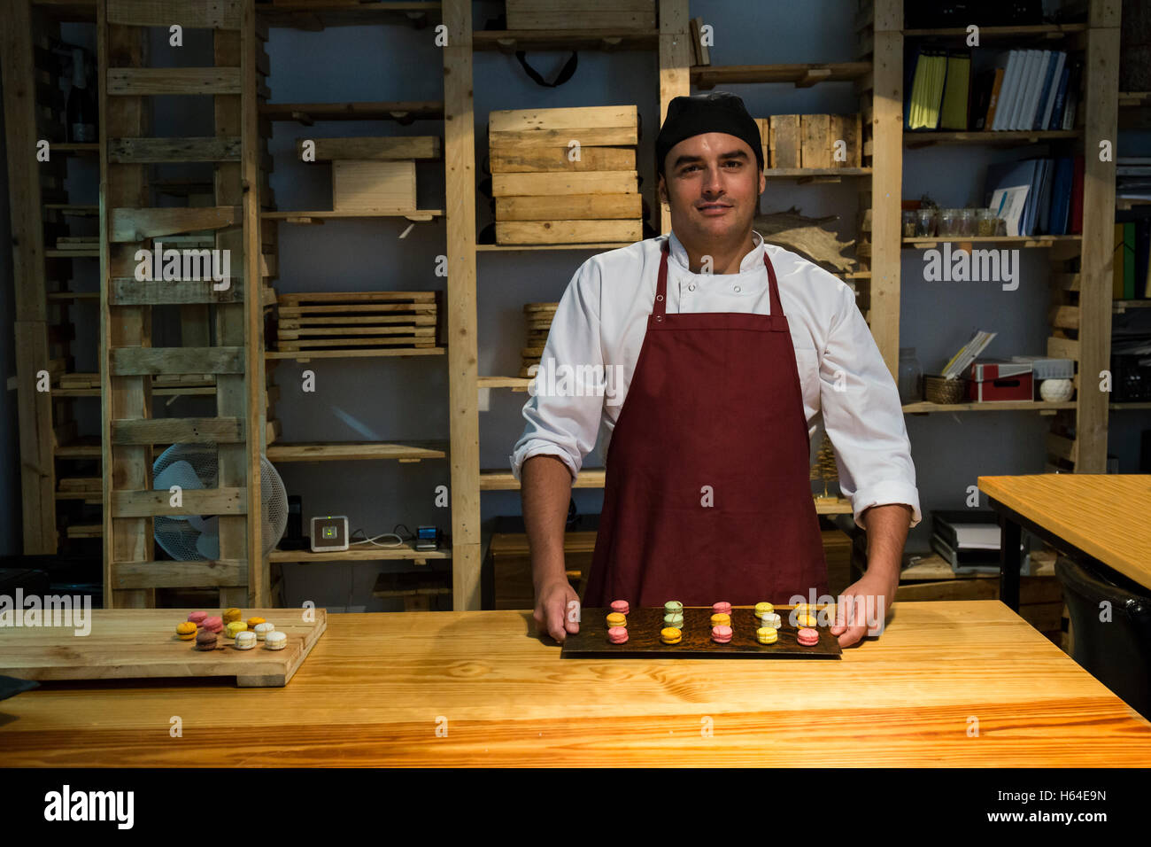 Man with a tray of macarons Stock Photo - Alamy