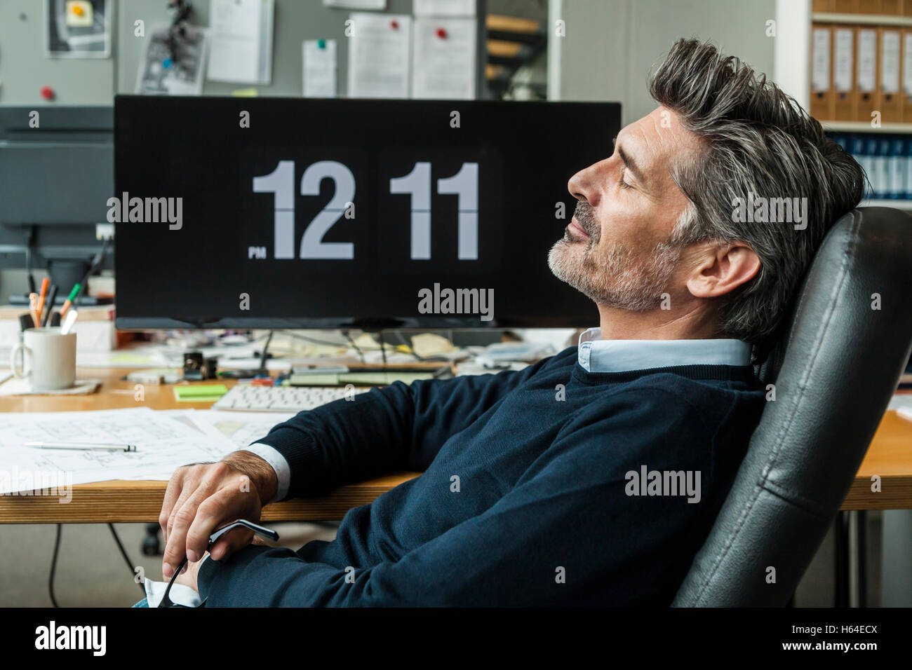 Mature man taking a nap at his office Stock Photo - Alamy