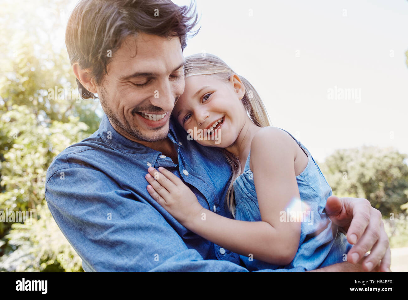 Father and daughter hugging outdoors Stock Photo - Alamy