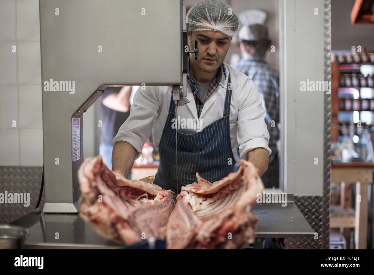 Butcher cutting carcass with bandsaw in butchery Stock Photo - Alamy