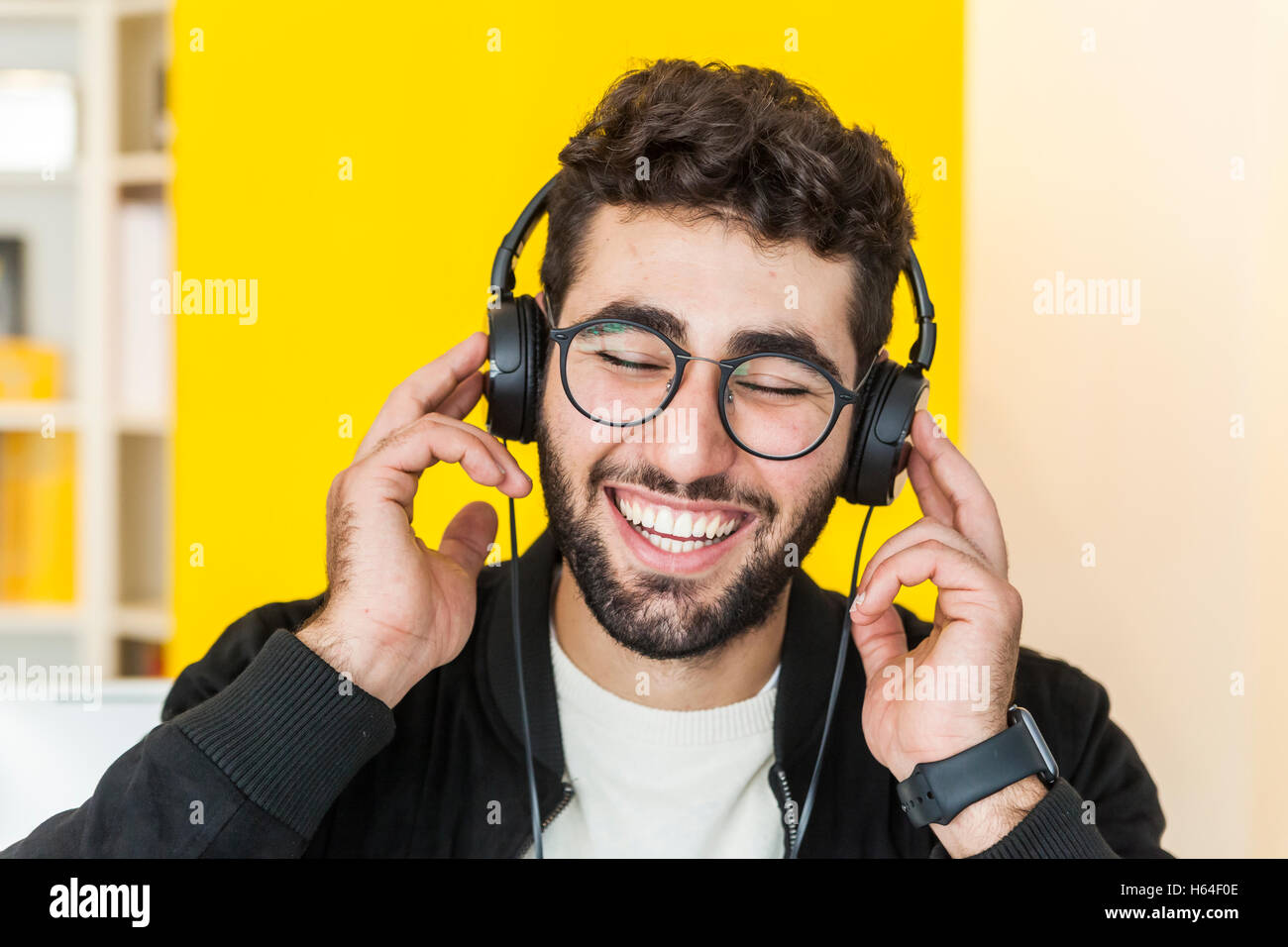 Portrait of laughing man with listening music with headphones Stock ...