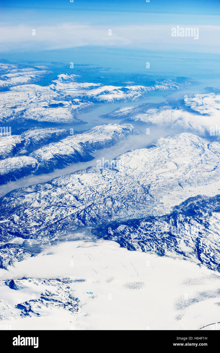 Greenland, view out of plane window on glaciers, fjords, sea and ...