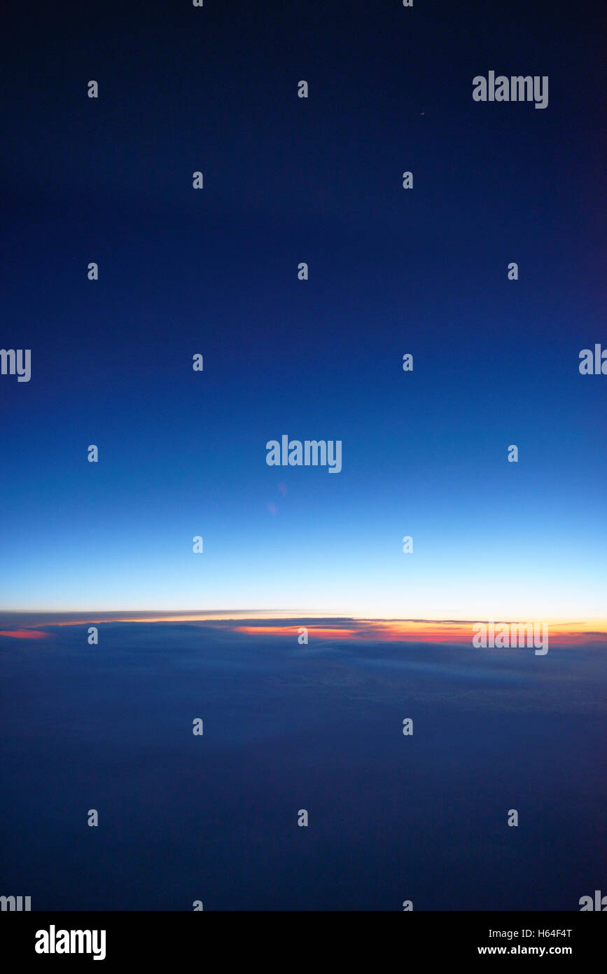 USA, view out of plane window on sunset above the clouds Stock Photo ...