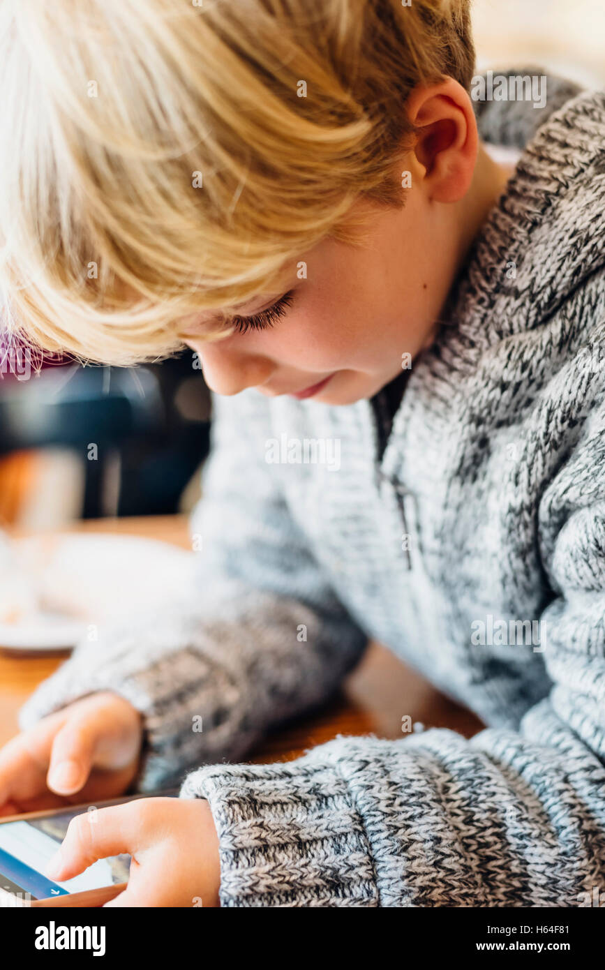 Boy looking at cell phone Stock Photo - Alamy