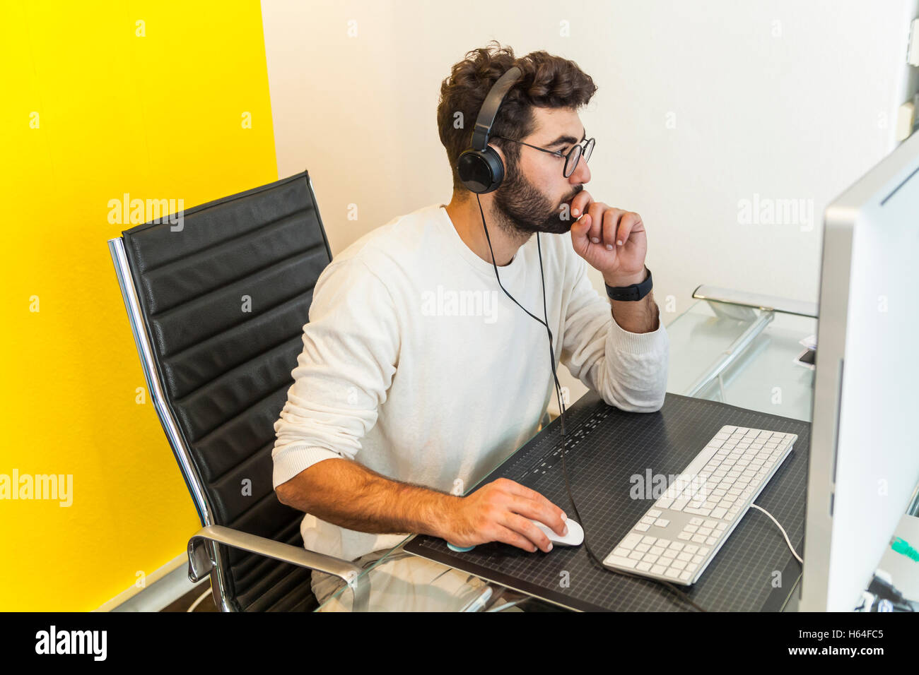 Young man working with computer in an office Stock Photo - Alamy