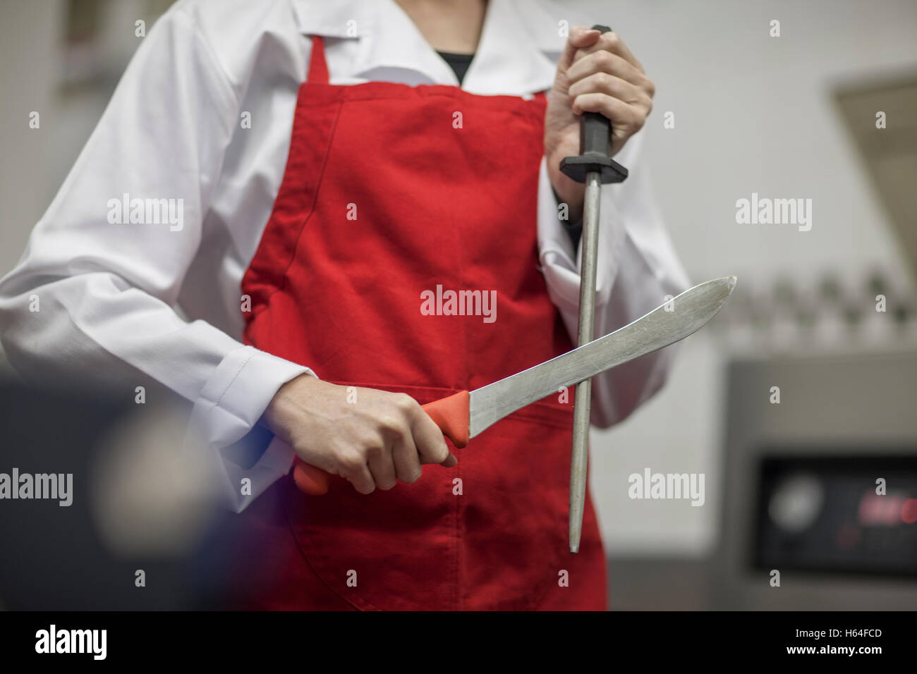 Butcher sharpening his knife Stock Photo - Alamy