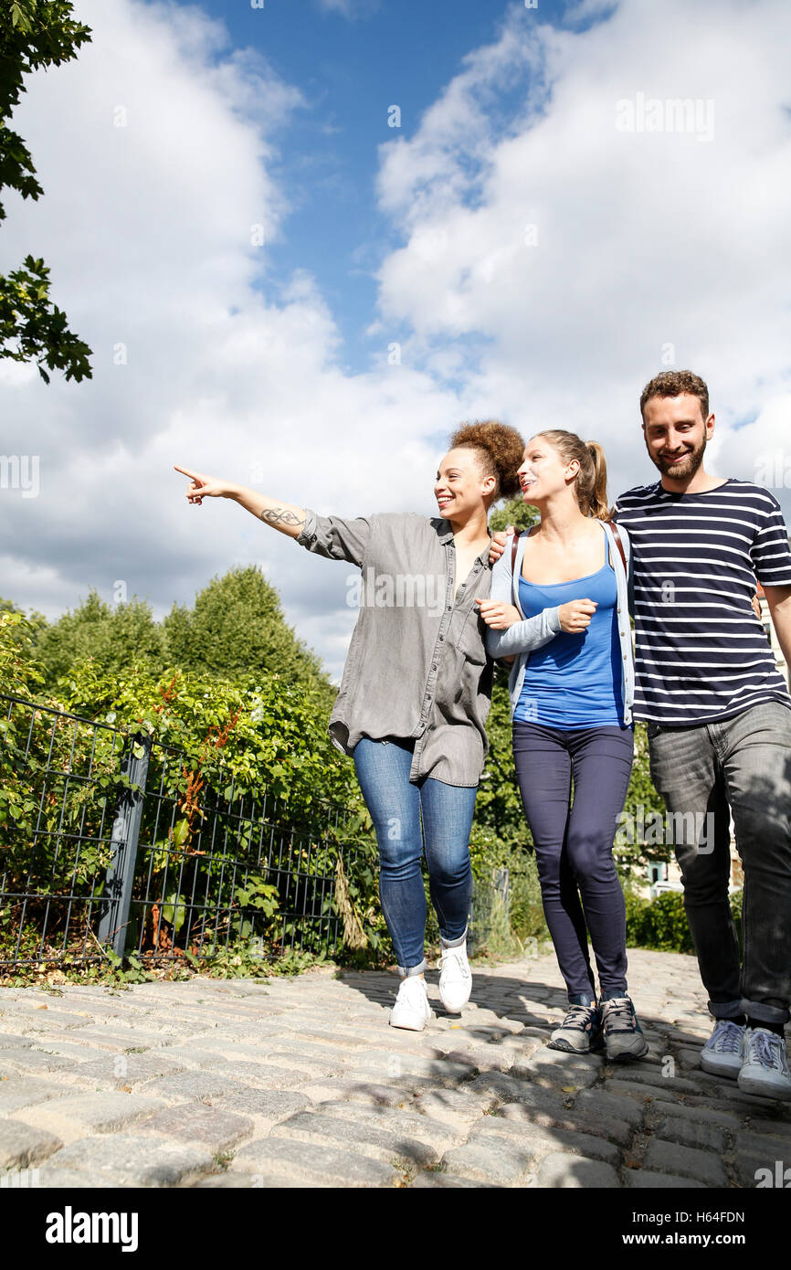 Happy friends walking in park Stock Photo - Alamy