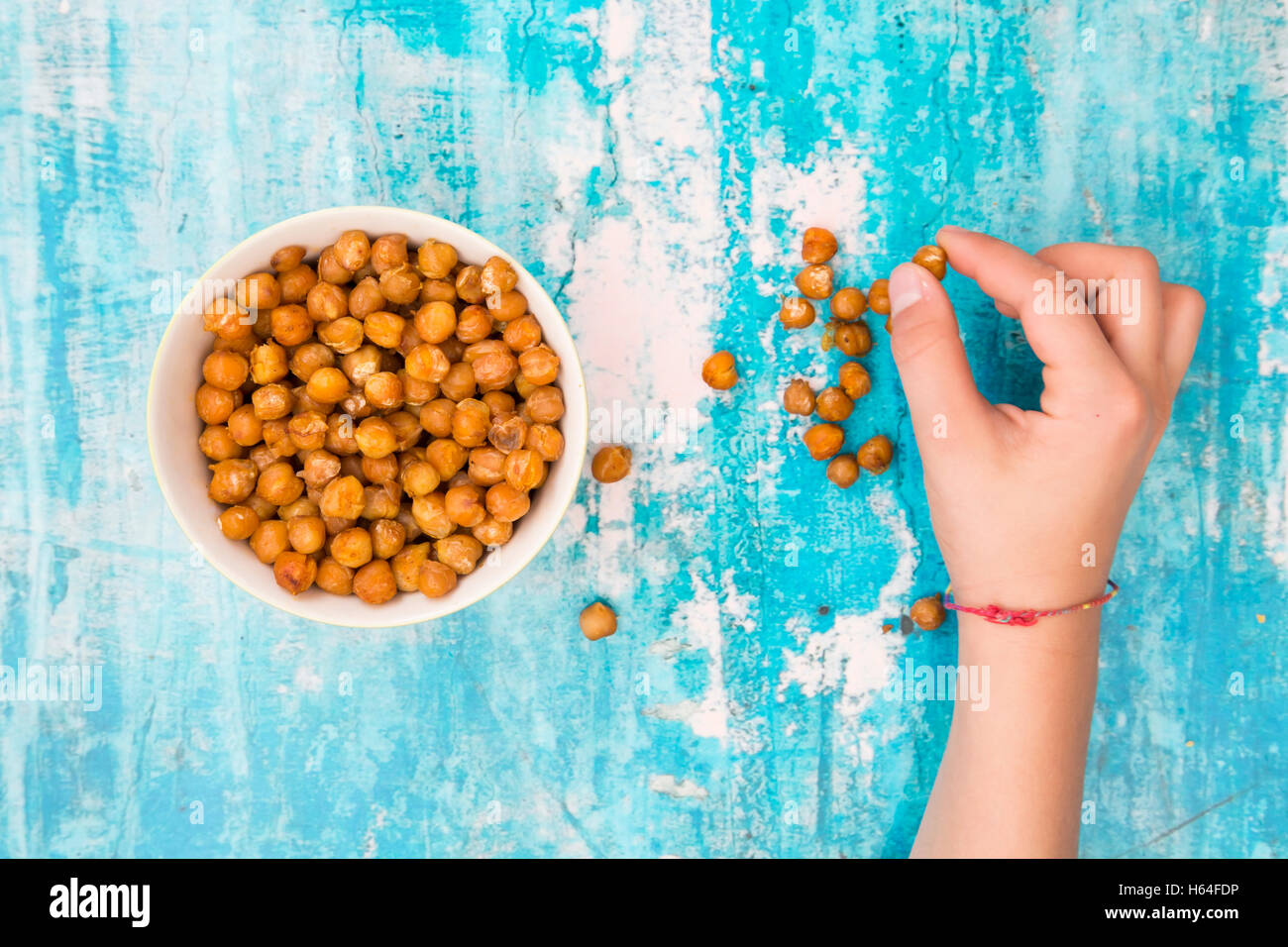 Hand of girl taking chickpea Stock Photo - Alamy