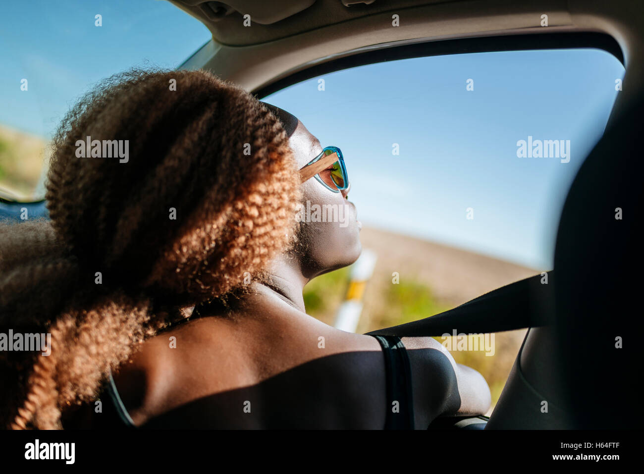 Young woman looking out of car window Stock Photo - Alamy