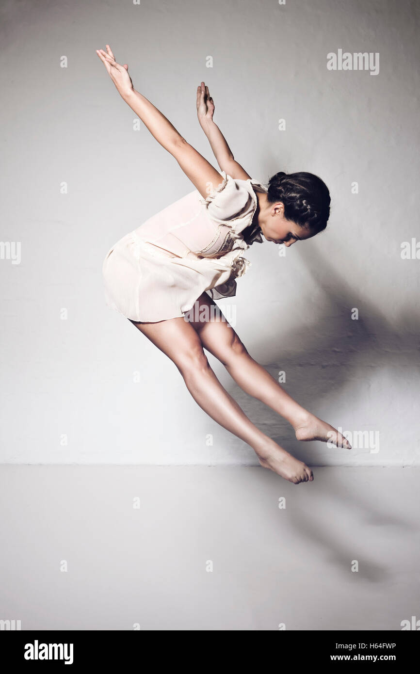 Dancer jumping in studio Stock Photo - Alamy