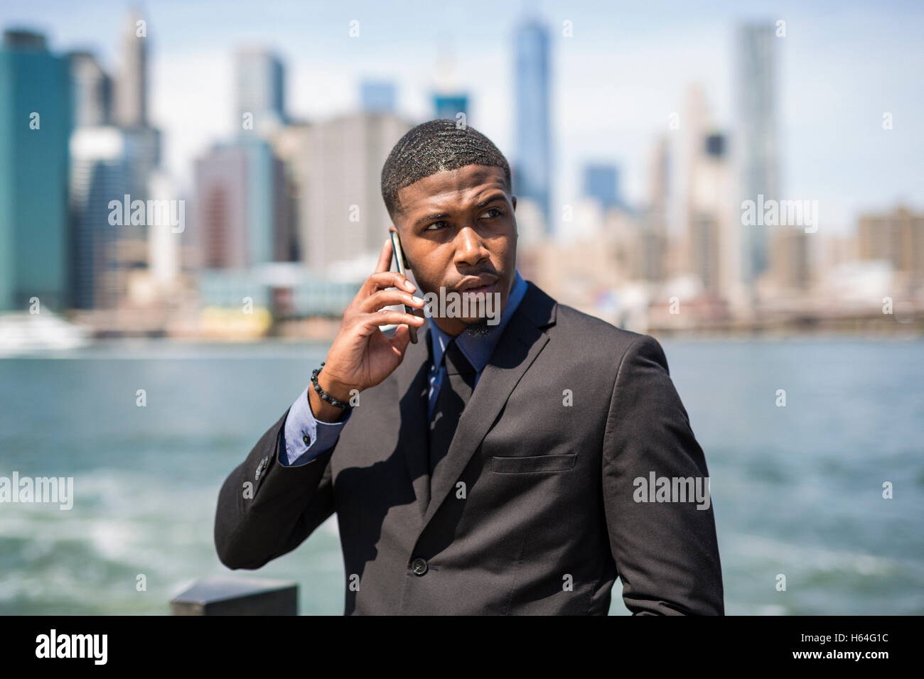 USA, Brooklyn, portrait of businessman on the phone in front of ...