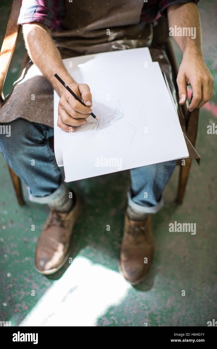 Man drawing in sketch book Stock Photo - Alamy