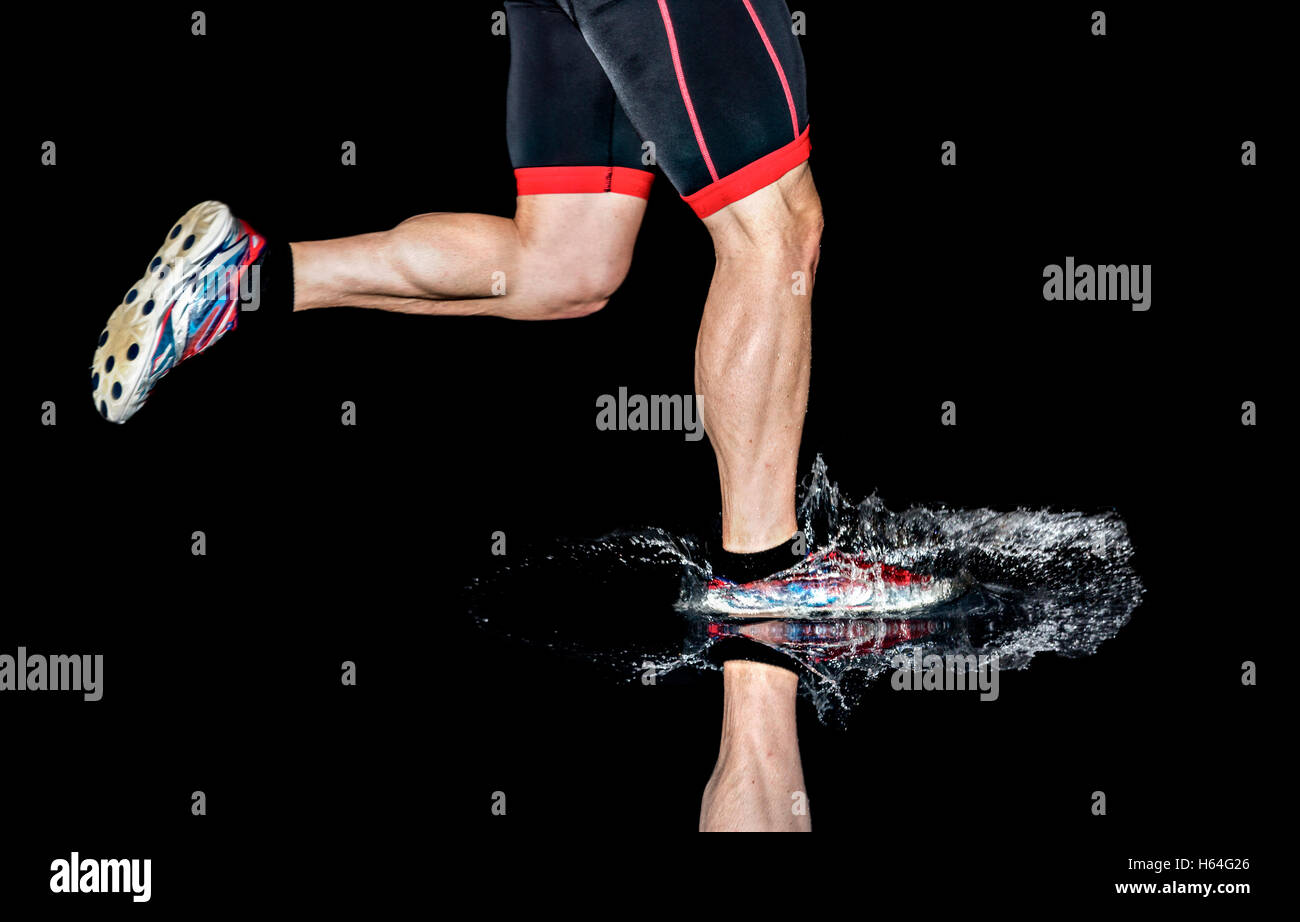 Athlete running in splashing water Stock Photo - Alamy