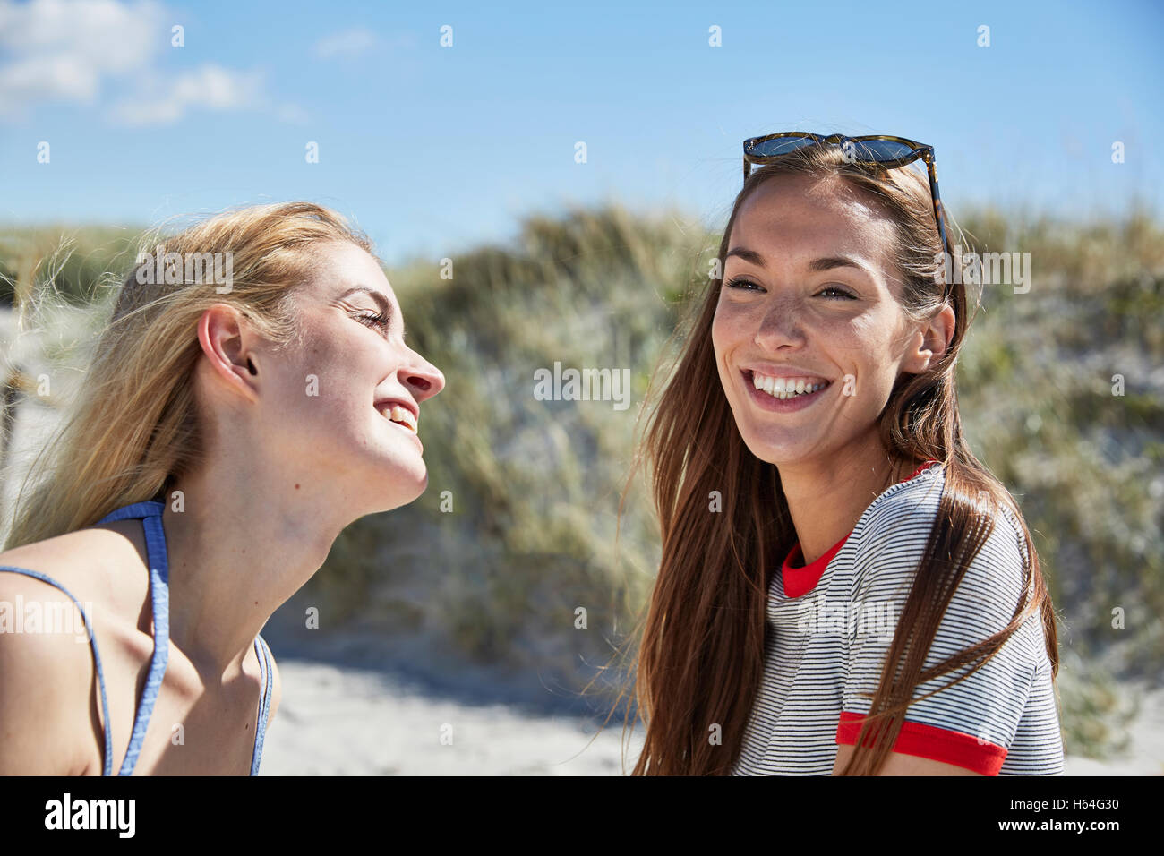 Two happy female friends on the beach Stock Photo - Alamy