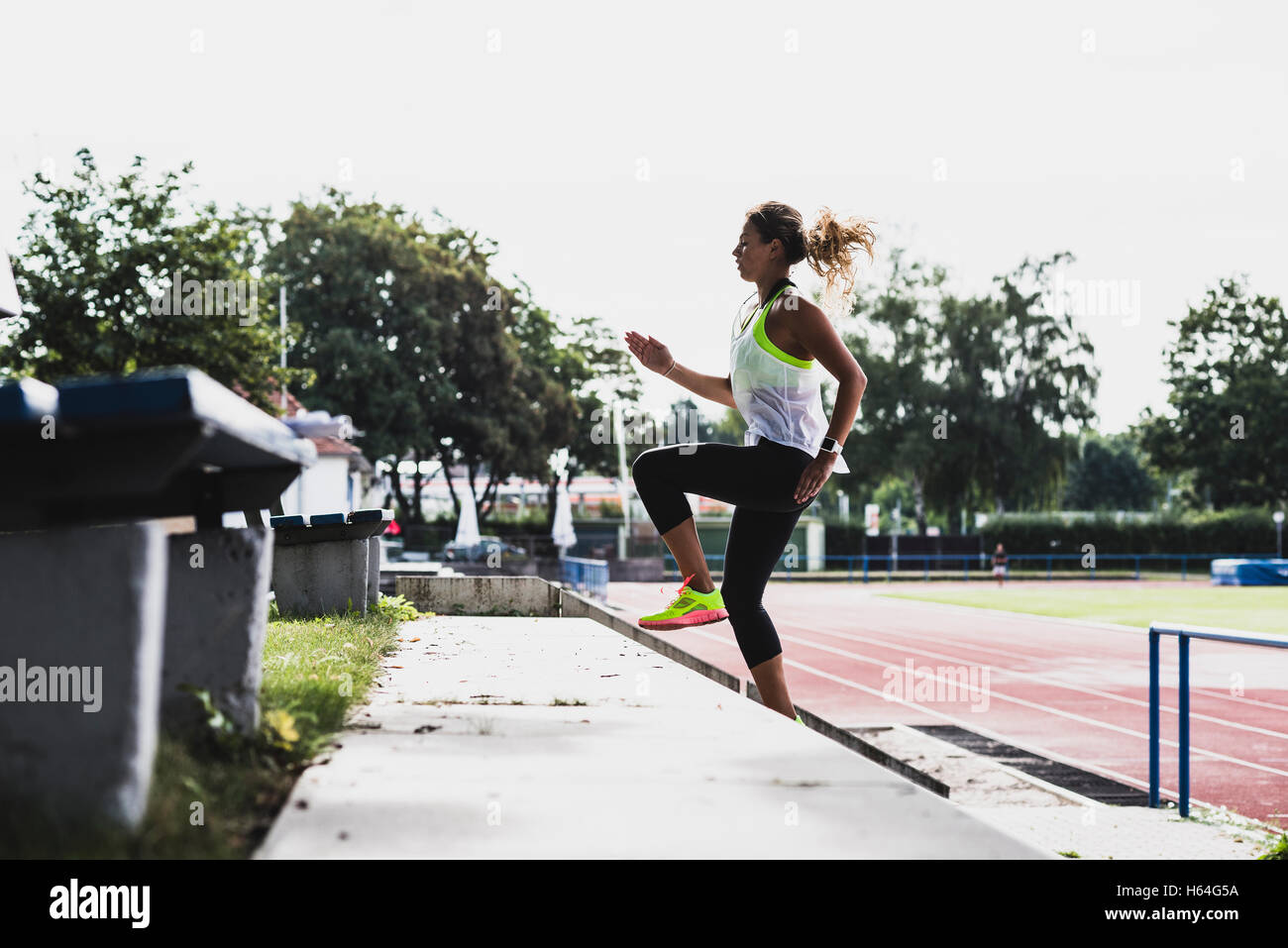 Young woman practicing in a track and field stadium Stock Photo - Alamy