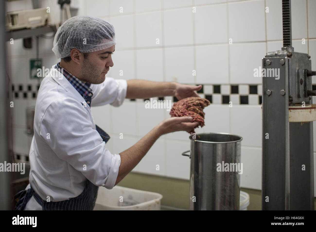 Butcher processing minced meat in butchery Stock Photo - Alamy