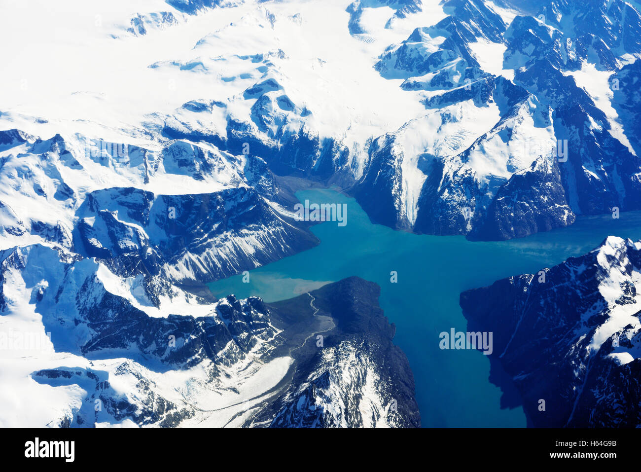 Greenland, view out of plane window on glaciers, fjords and mountains ...