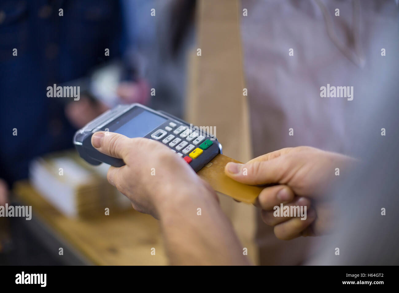 Salesperson using card reader for card payment Stock Photo - Alamy