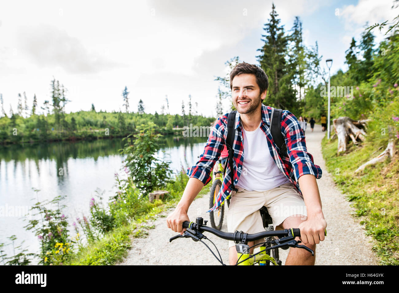 Young man riding bicycle in nature Stock Photo - Alamy
