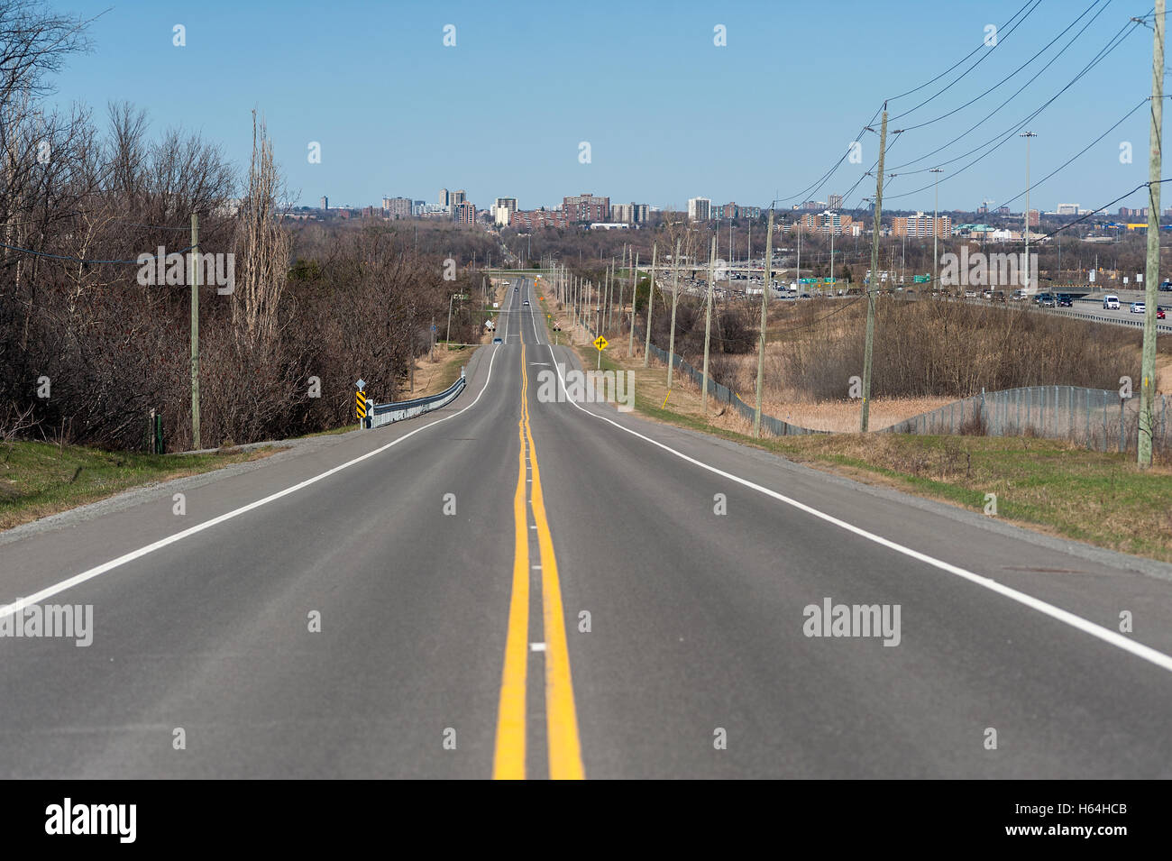 Straight road into city Stock Photo - Alamy
