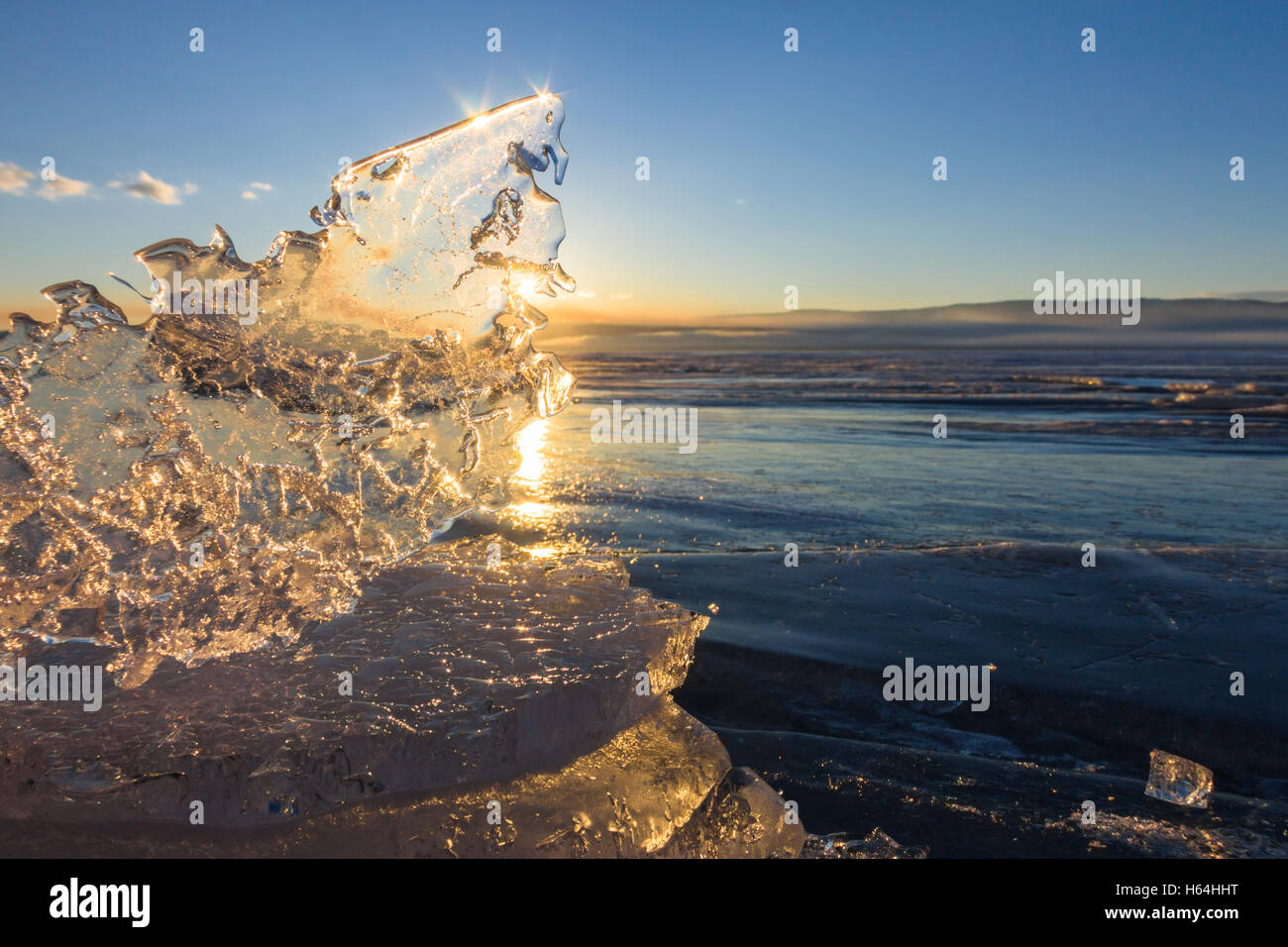Sun at sunset shining through the transparent texture of the ice floe ...