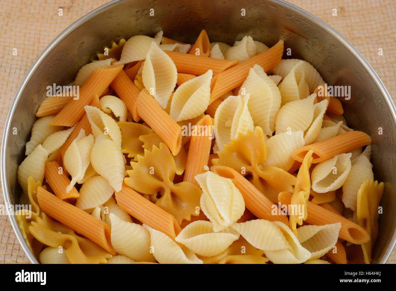 Variety of cooked pasta in stainless steel bowl Stock Photo - Alamy