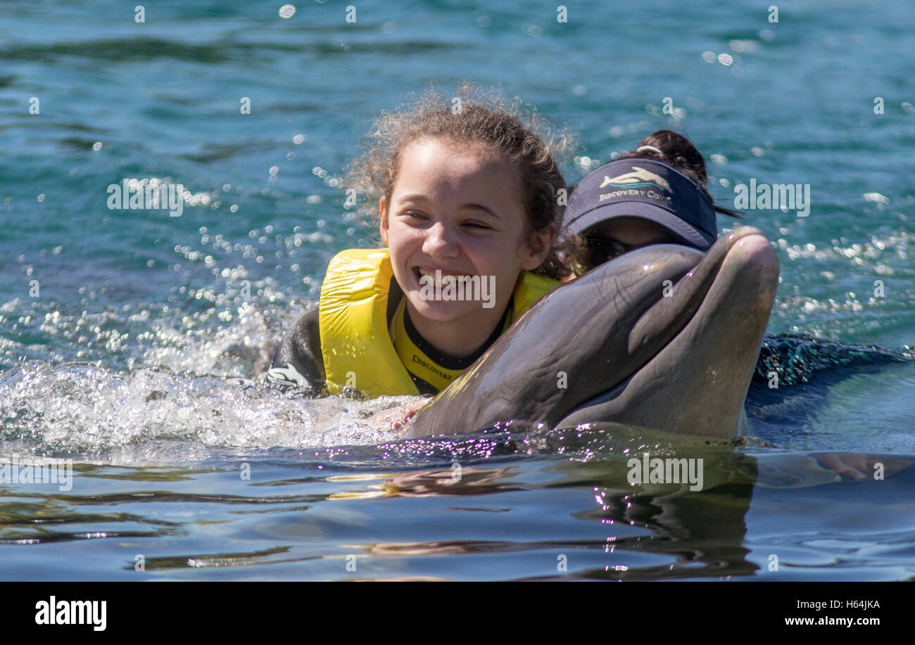 Courtney Cassidy, 12, from Glasgow, enjoys a swim with a dolphin during ...