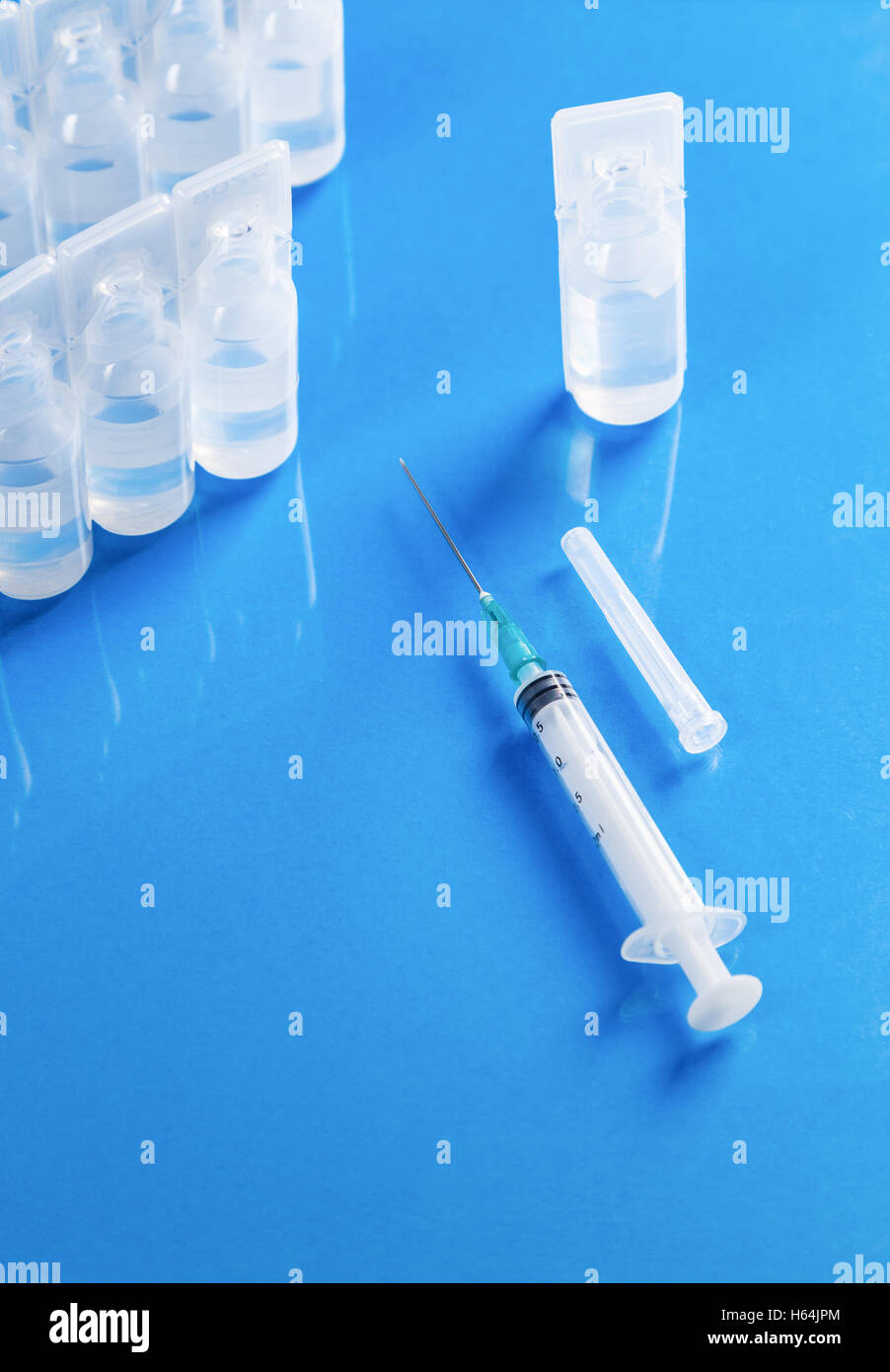 Syringe and vials on blue background.Useful for medical background ...