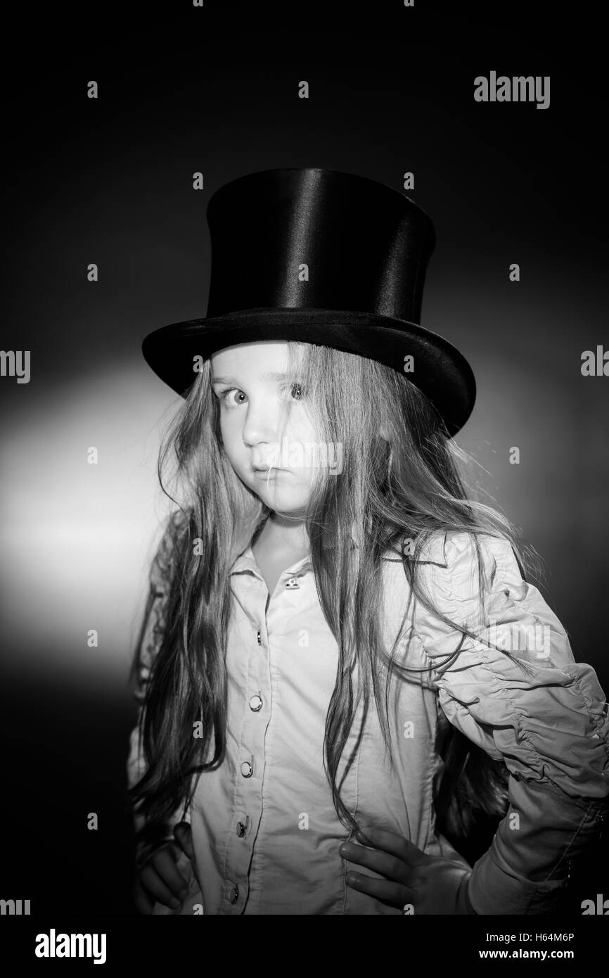 Cute little girl posing in gibus, old-style opera hat, vintage photo ...