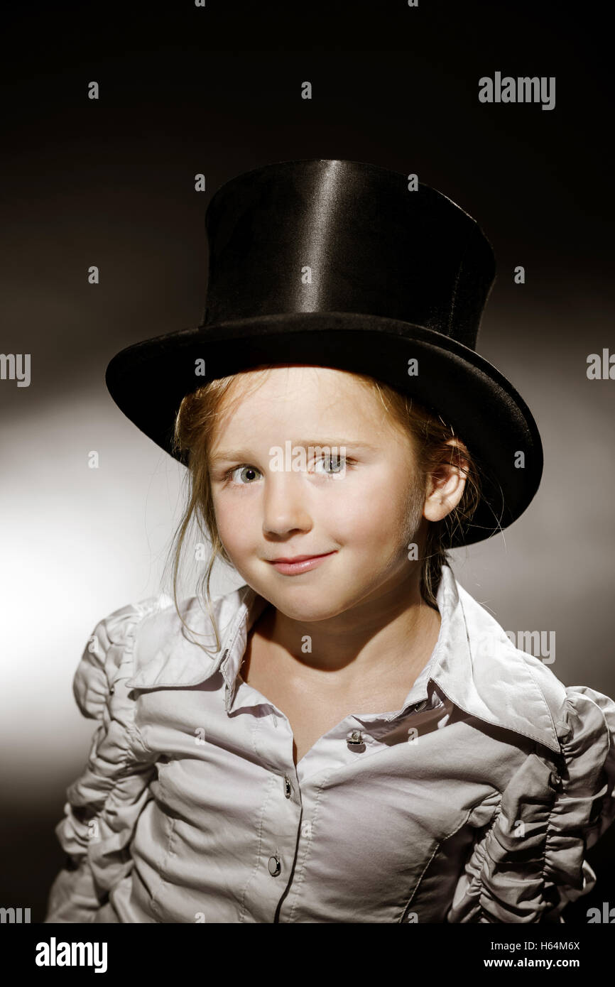 Cute little girl posing in gibus, old-style opera hat, vintage photo ...