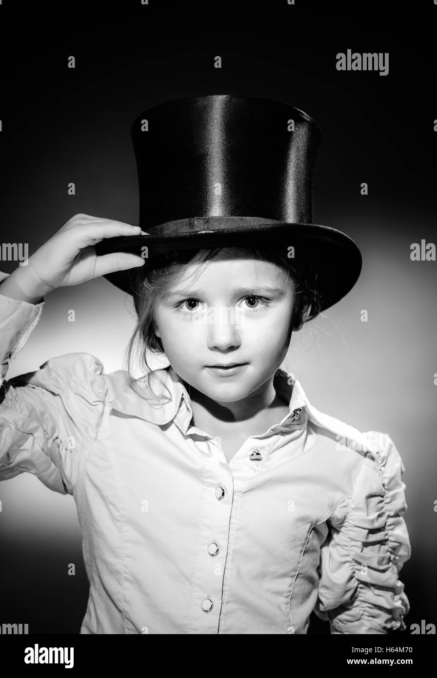 Cute little girl posing in gibus, old-style opera hat, vintage photo ...