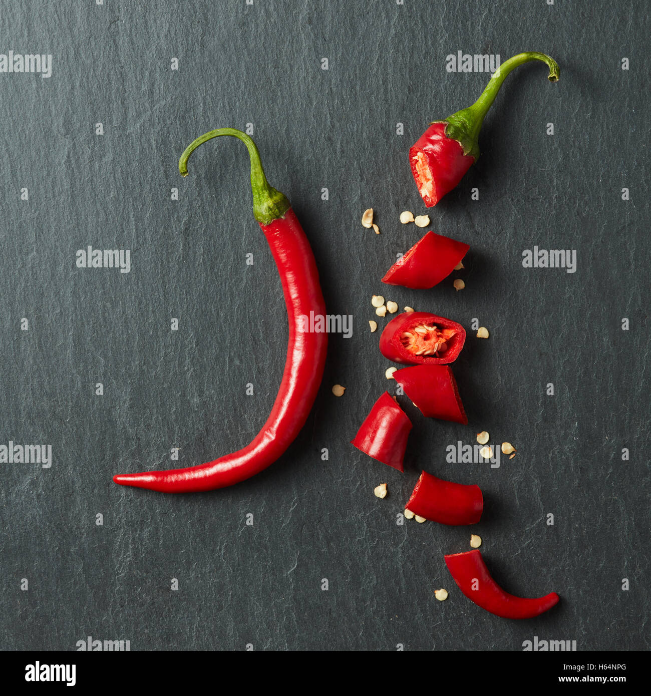 Fresh chopped red chili on a black concrete background Stock Photo - Alamy