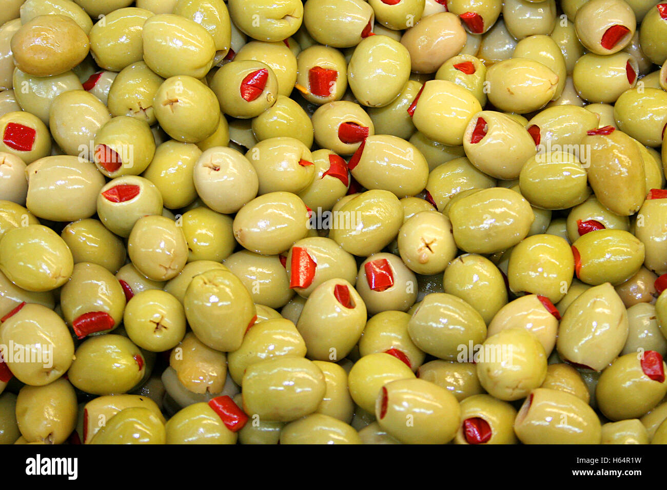Red pepper Stuffed Green Olives Stock Photo - Alamy